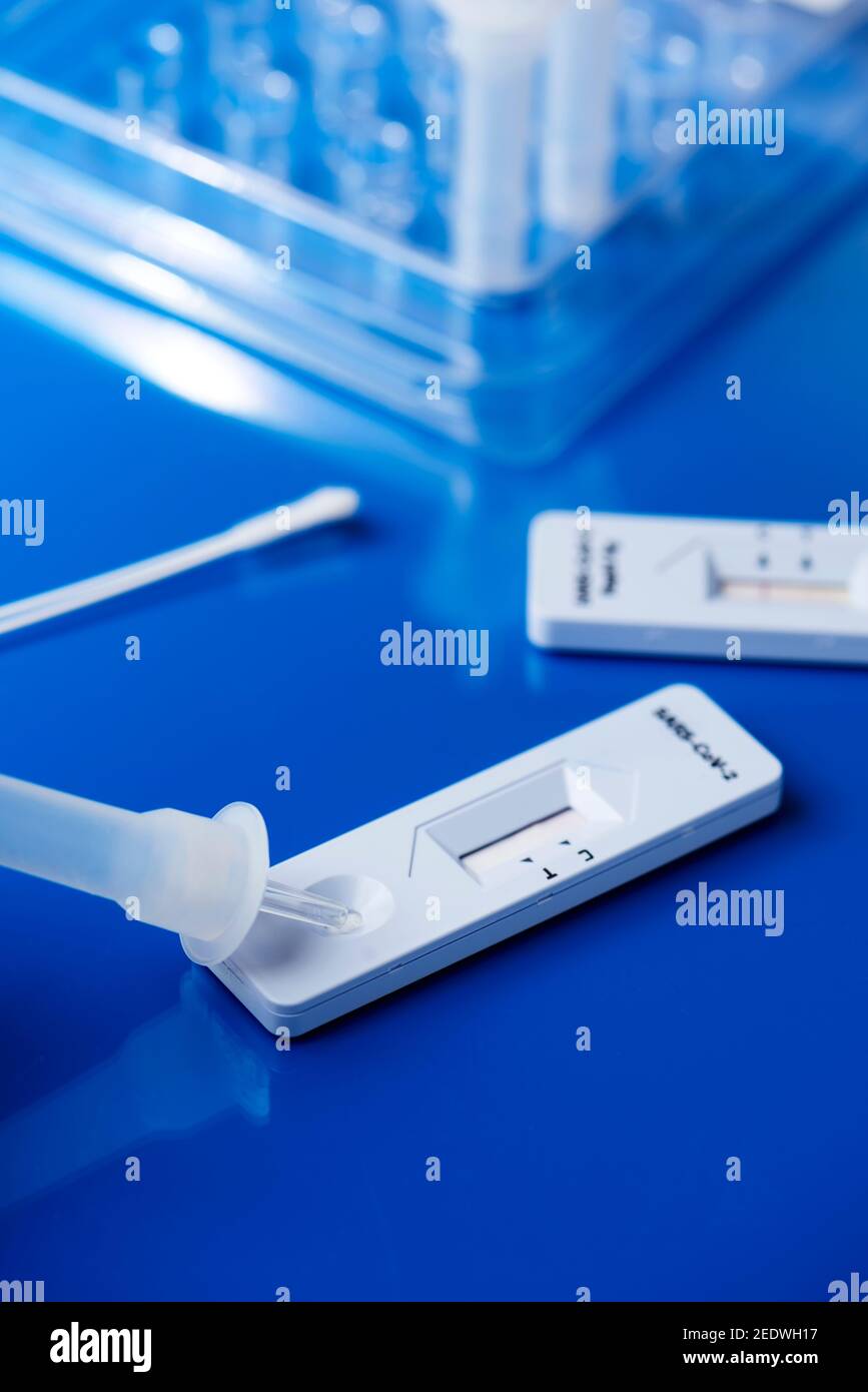 closeup of a sample being placed into a covid-19 rapid antigen test ...