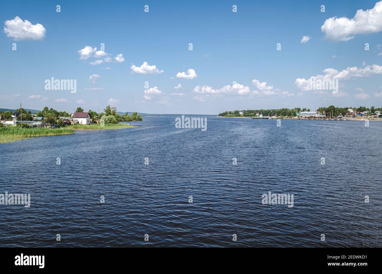 Rural landscape of lake bay with clouds, waves on water Stock Photo - Alamy