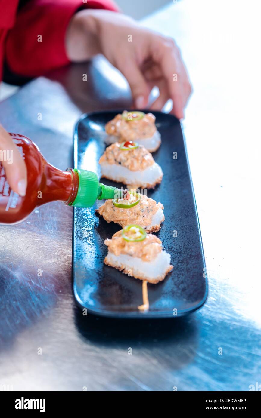 Chef plating finished appetizer Stock Photo - Alamy