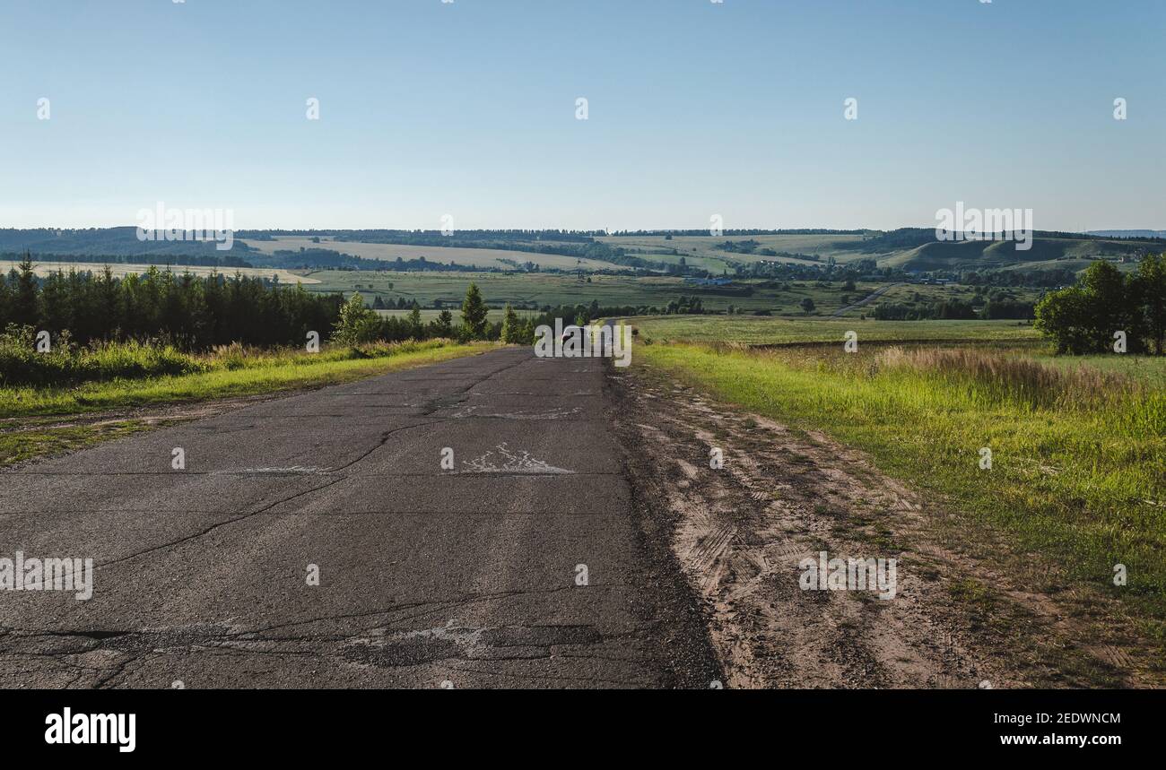Asphalt road in rural, landscape with forest and meadows Stock Photo ...