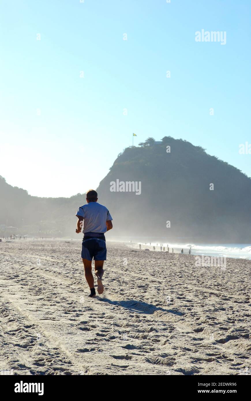 Man running on the Copacabana beach Stock Photo - Alamy