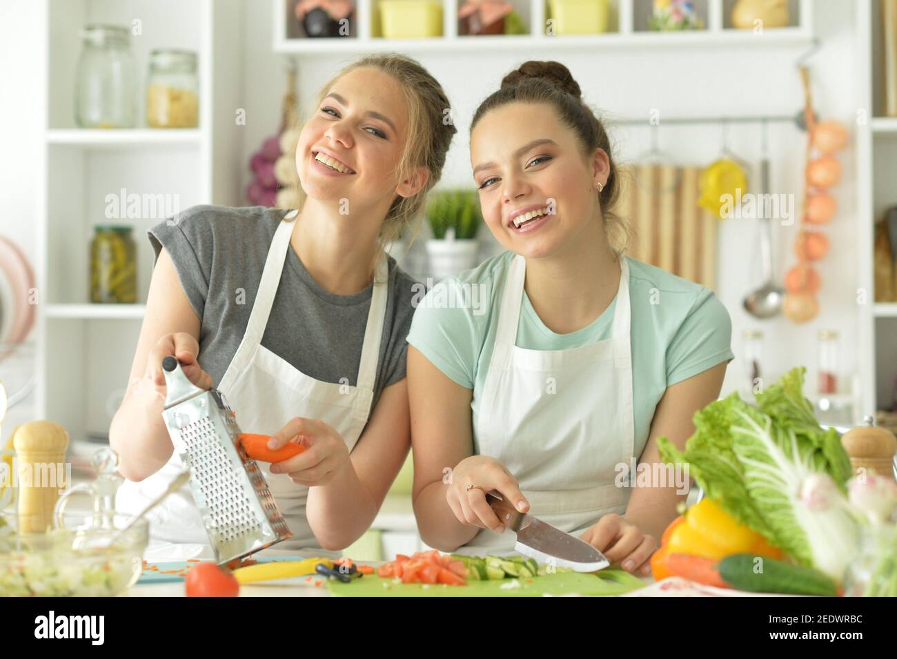 Portrait of beautiful teenagers cooking in kitchen Stock Photo - Alamy
