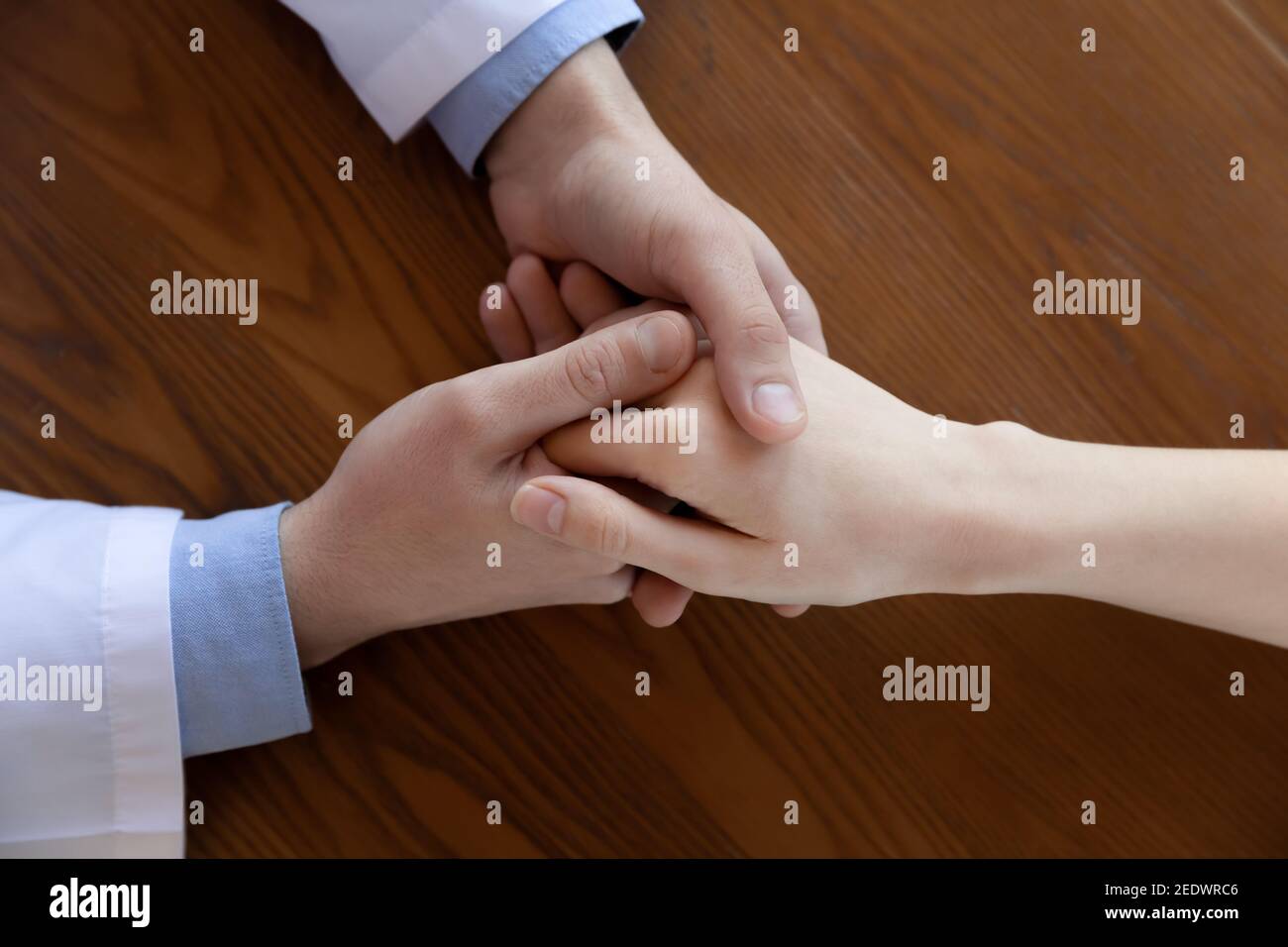 Top view compassionate male general practitioner supporting patient ...