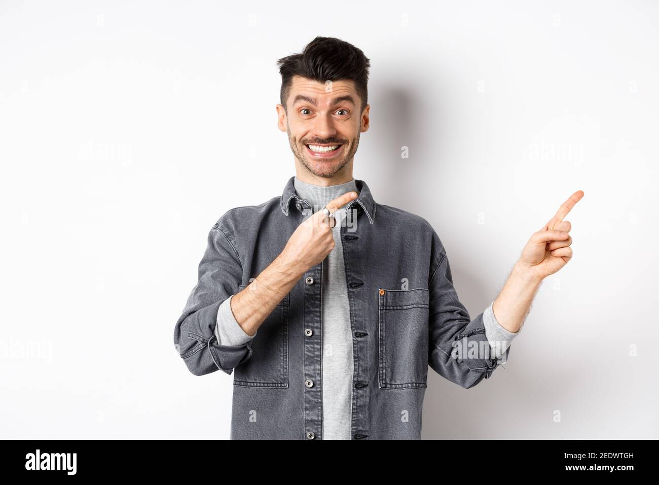 Cheerful stylish man with moustache and white smile, pointing fingers ...