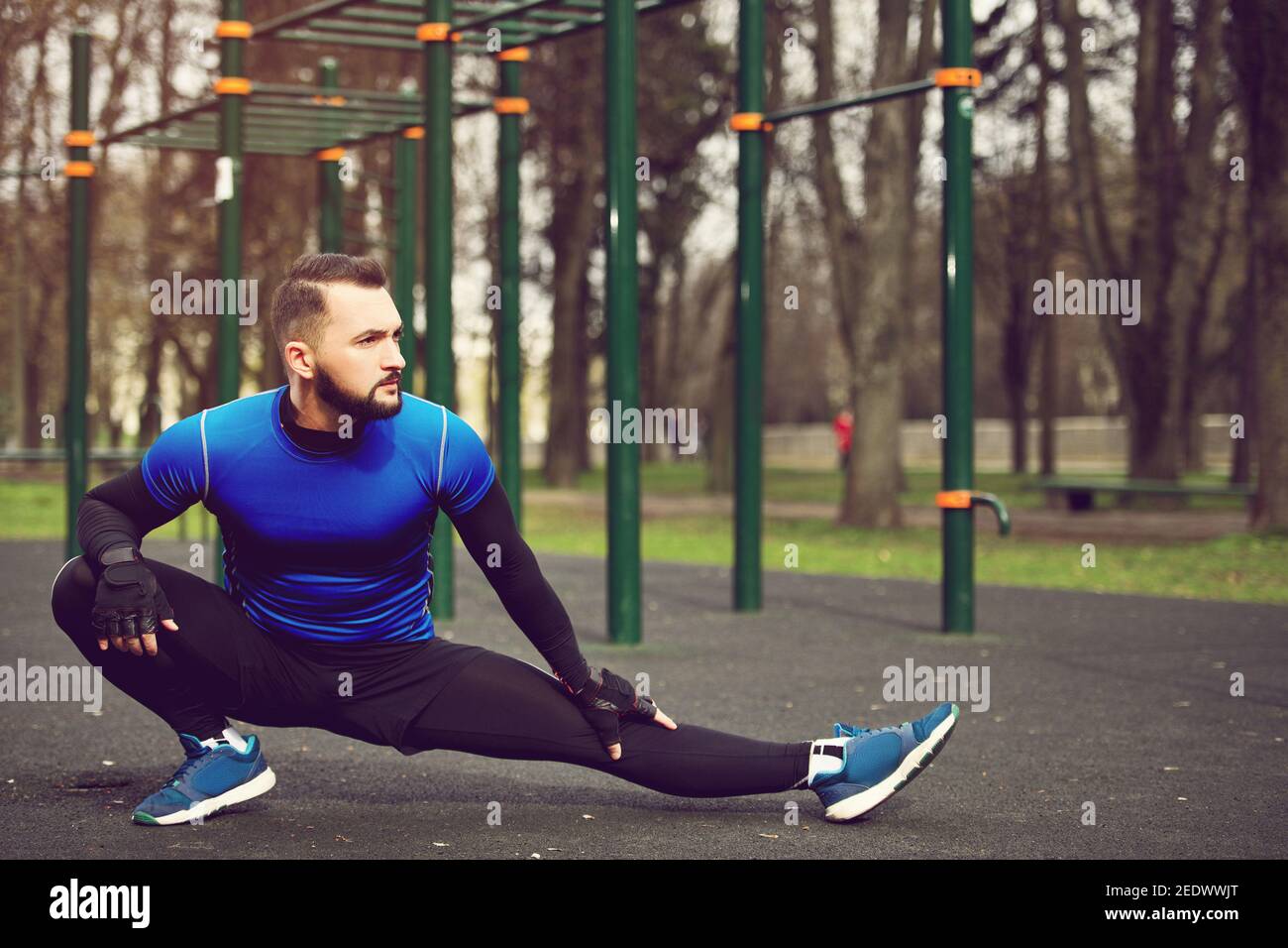 Young strong man stretches his muscles before training Stock Photo - Alamy