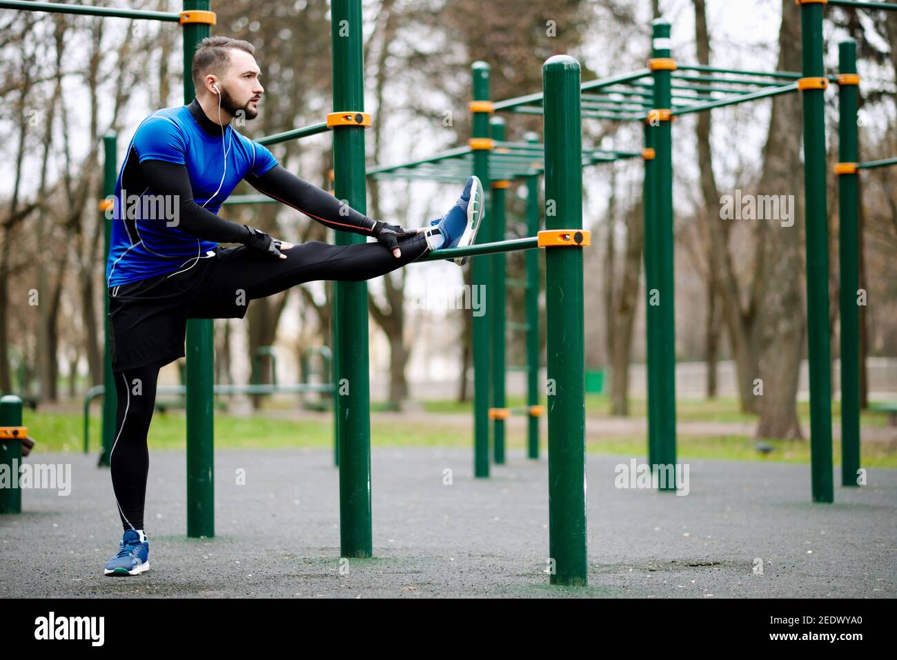 Young strong man stretches his muscles before training Stock Photo - Alamy