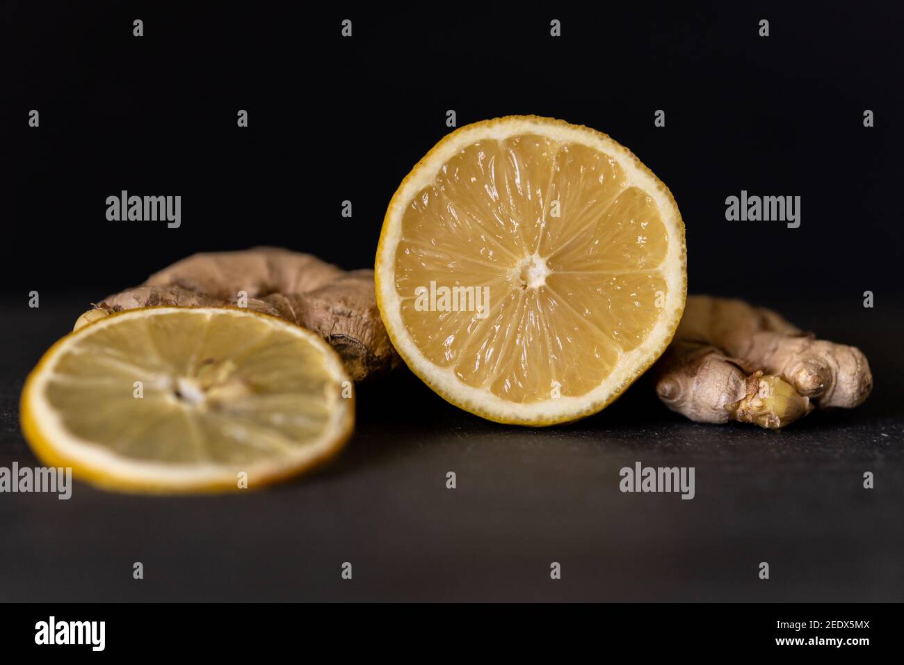 lemon with ginger lying healthy on a dark plate Stock Photo - Alamy