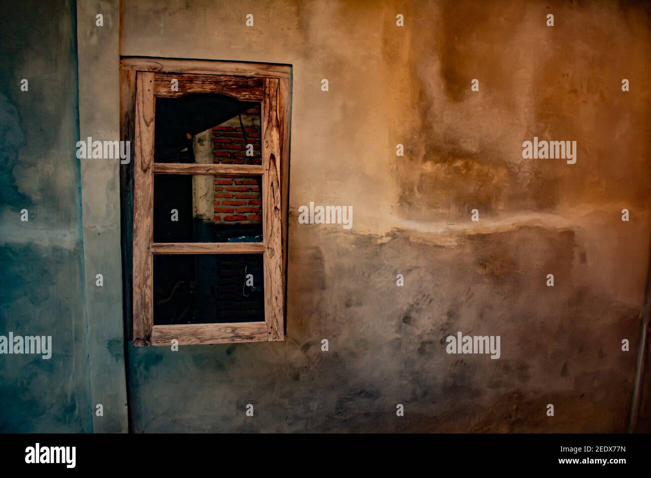 Half open wooden window on yellow brown grained plastered wall Stock ...