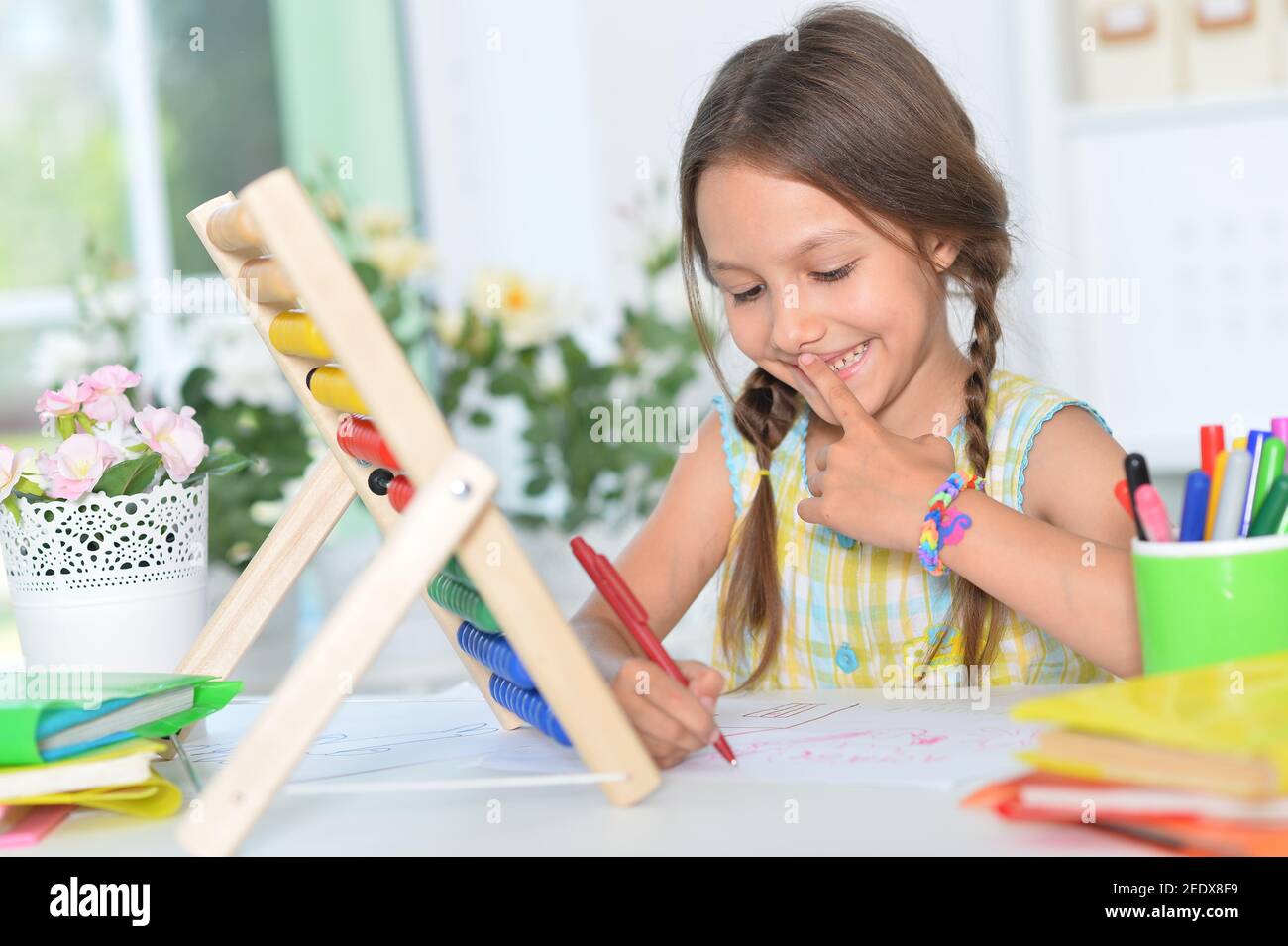 Cute little girl learning to use abacus Stock Photo - Alamy