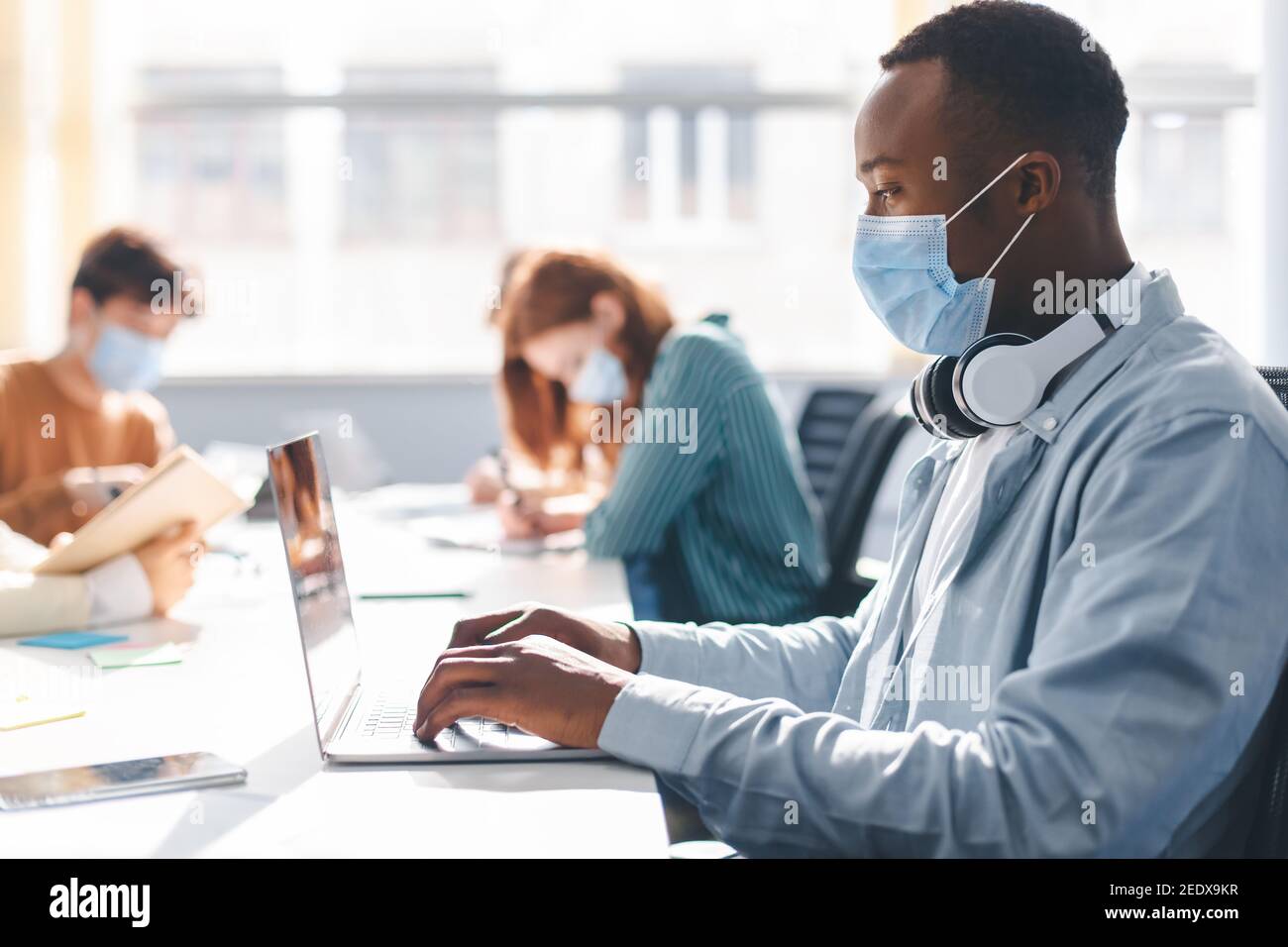 International people wearing medical face masks using laptop Stock ...