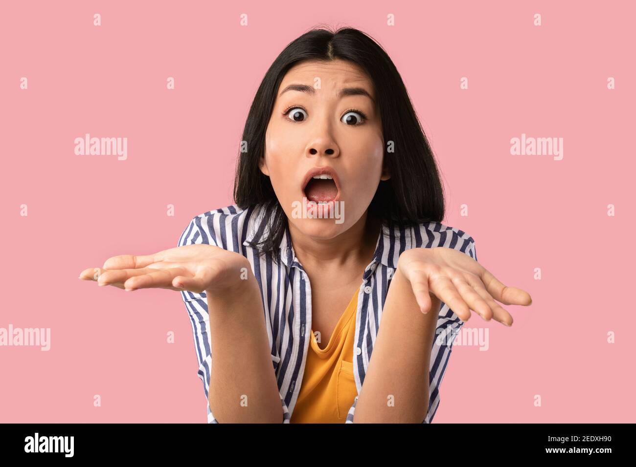 Surprised young asian woman staring at camera Stock Photo - Alamy