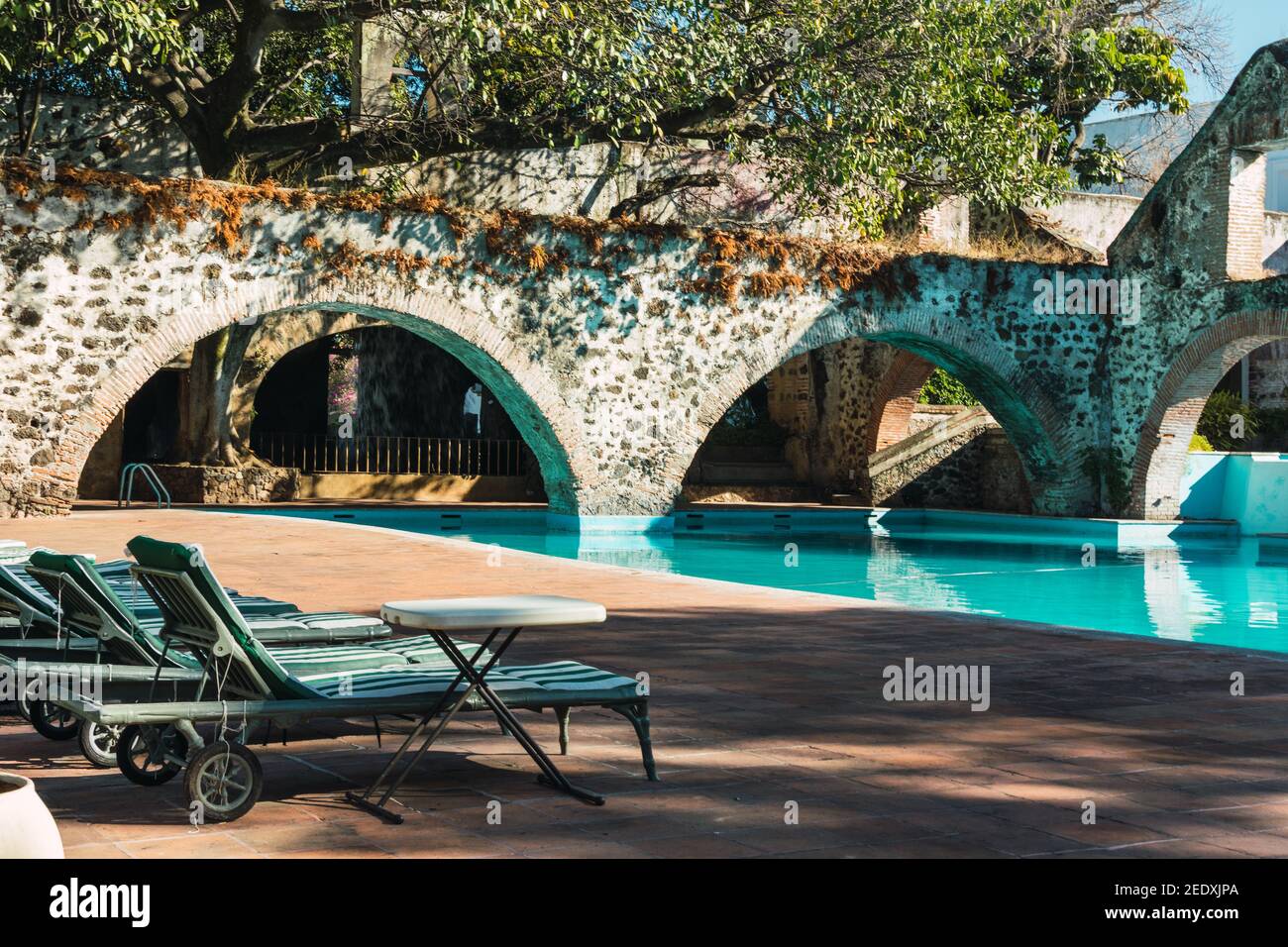 Pool and lounge chairs in an old hacienda, in Mexico, morelos, cocoyoc ...