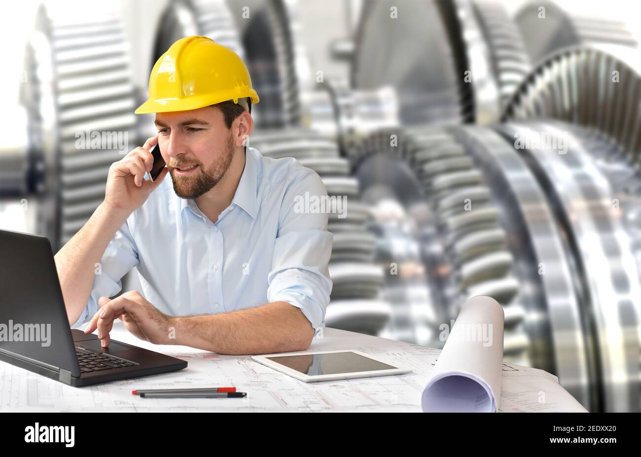 engineer at his workplace with notebook in an industrial company in ...