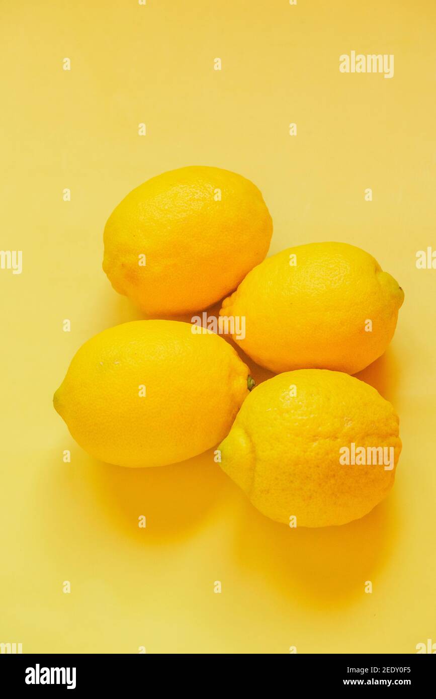 High Angle View Of Lemon Arranged Over Yellow Background. lemon, yellow ...