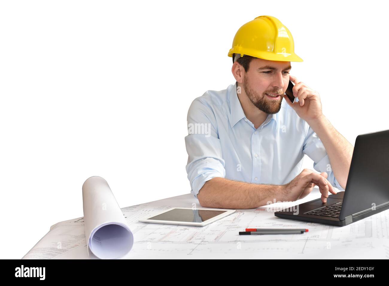 Architect / engineer at his desk planning the construction of a house ...