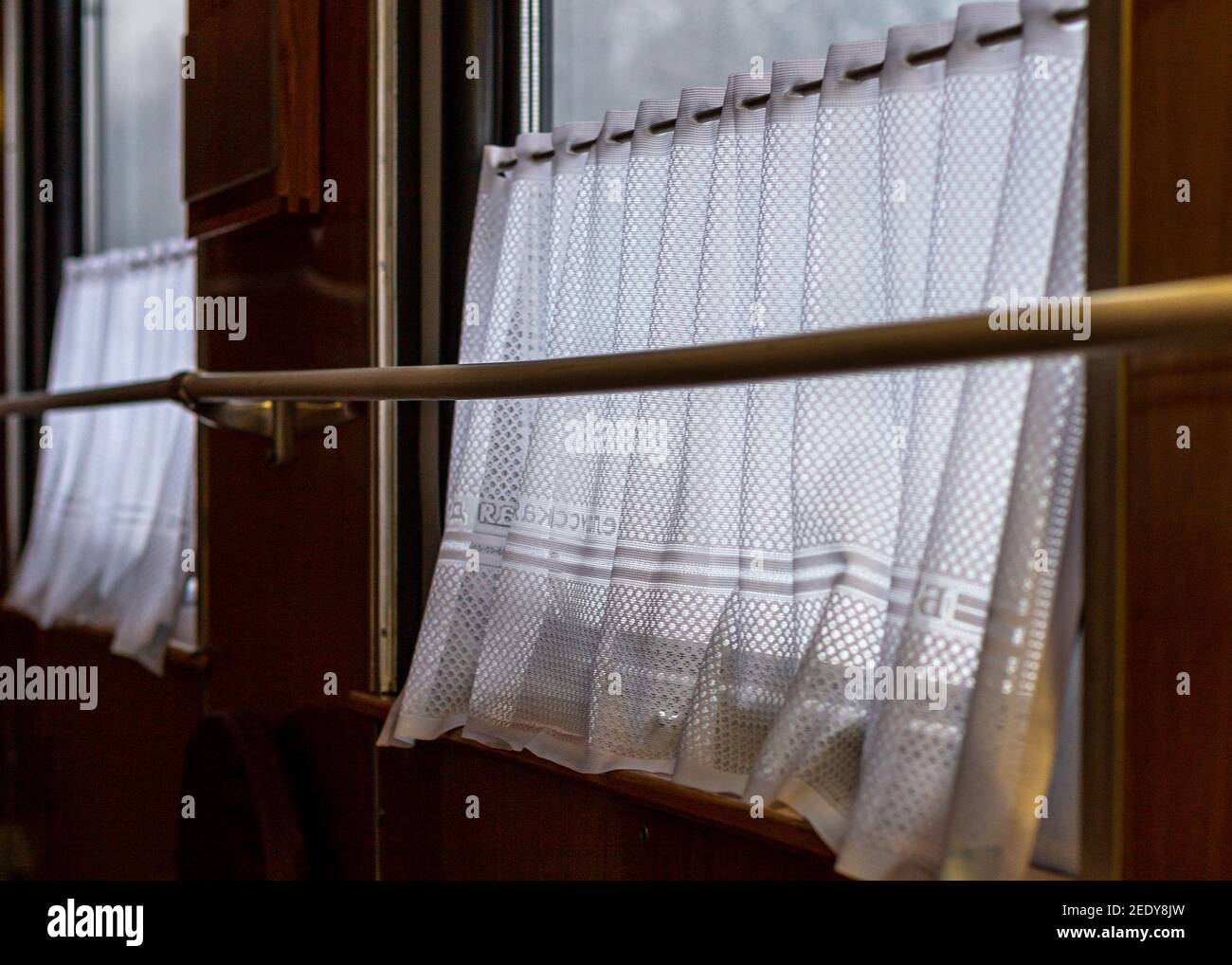 Lace curtains on the window in the train carriage Stock Photo - Alamy
