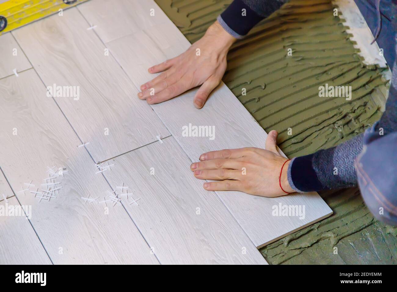 Handyman lay floor tiles home hi-res stock photography and images - Alamy
