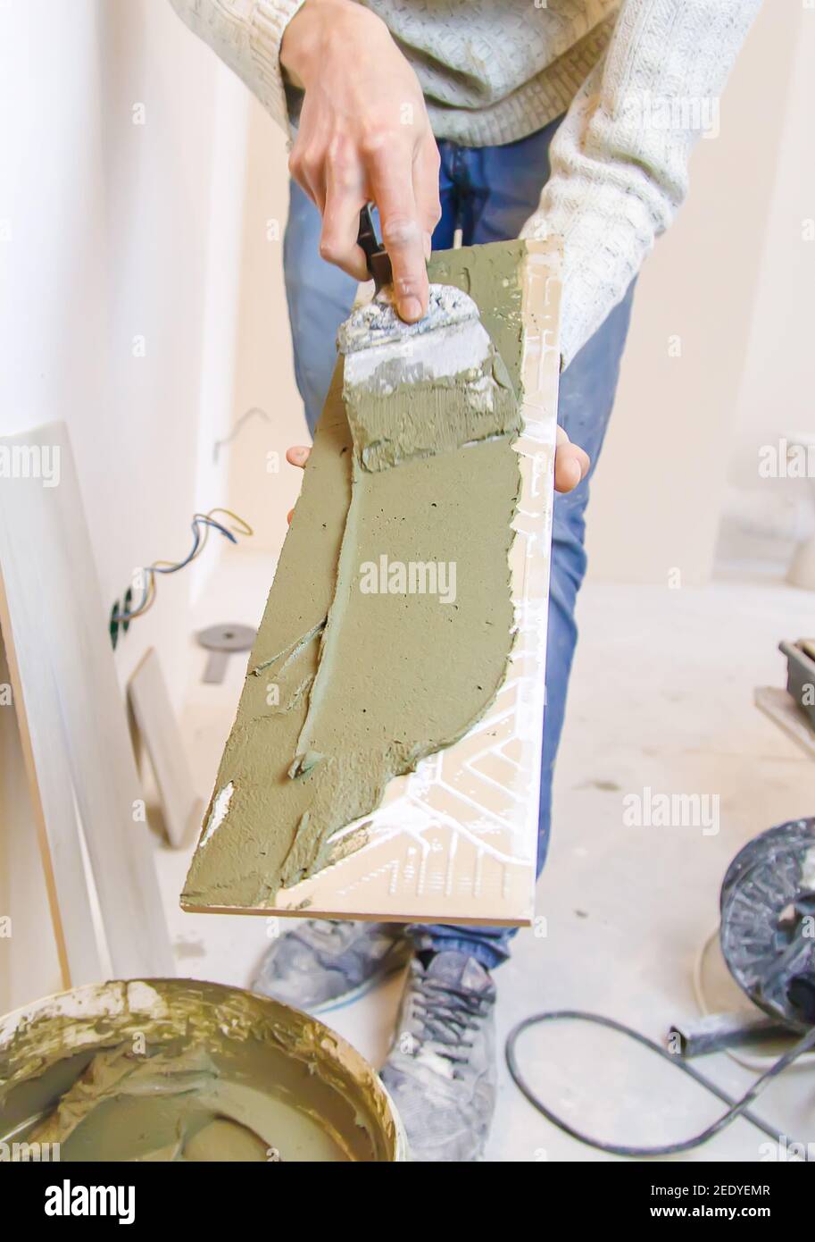 smear the tile repair in the house with a solution. Selective focus ...