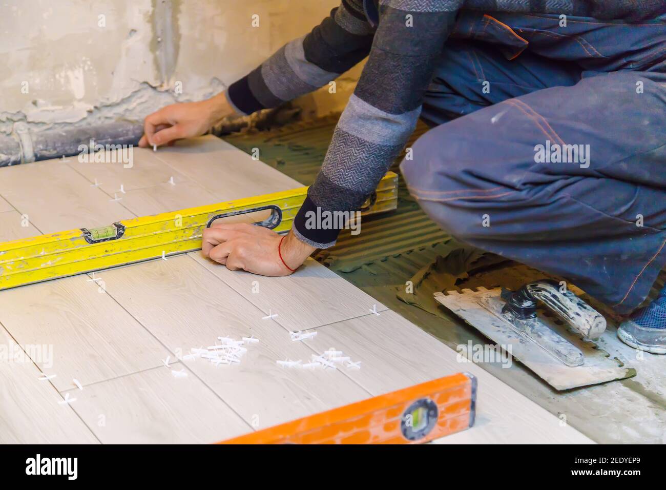Handyman lay floor tiles home hi-res stock photography and images - Alamy