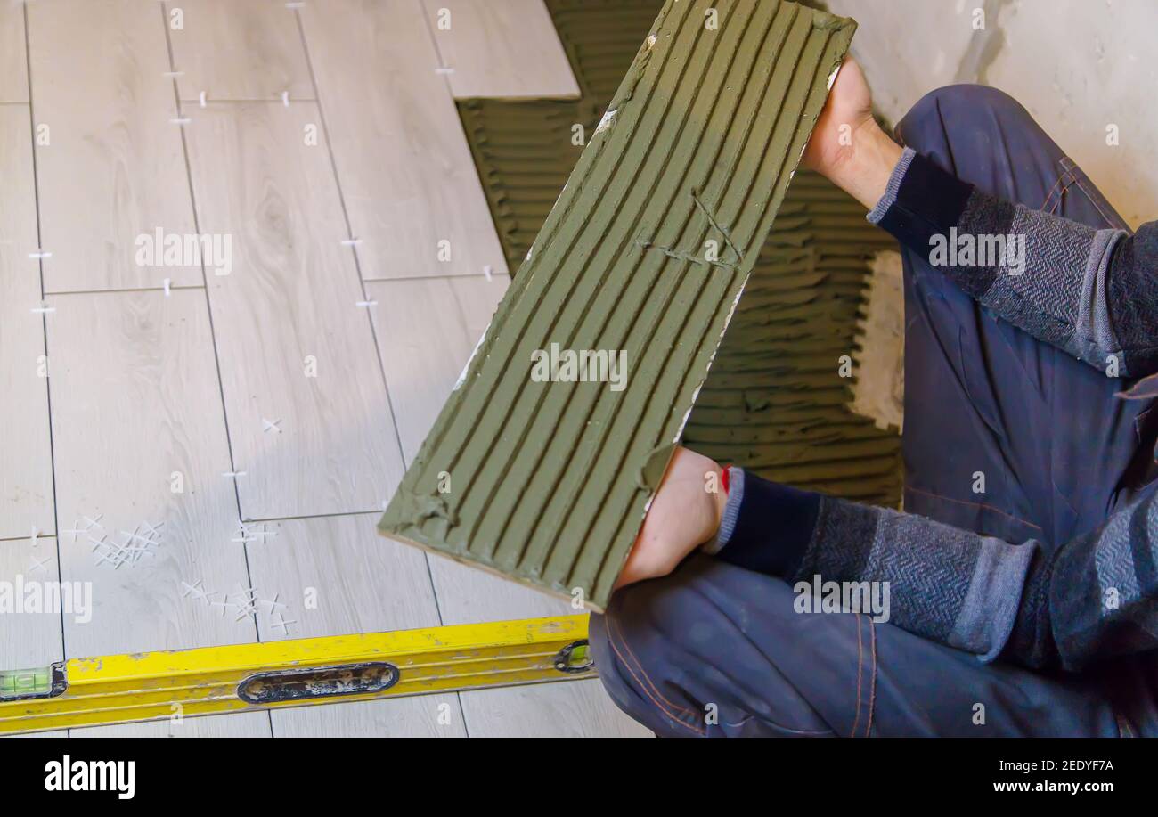 Handyman lay floor tiles home hi-res stock photography and images - Alamy