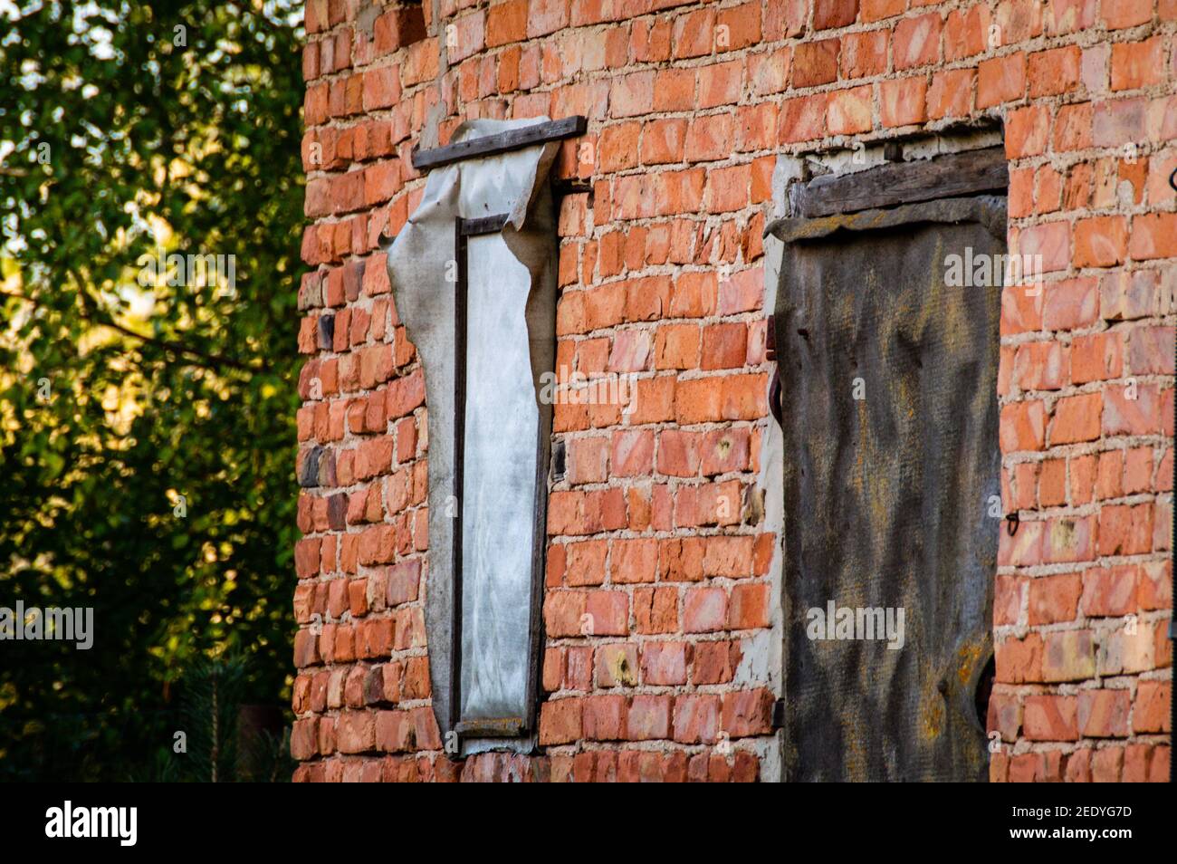 Old brick wall with closed window. Unstable and unsafe brick wall. Work ...