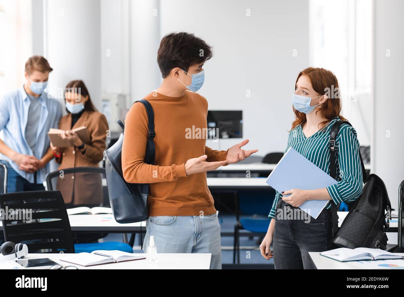 International students wearing medical masks and talking Stock Photo ...