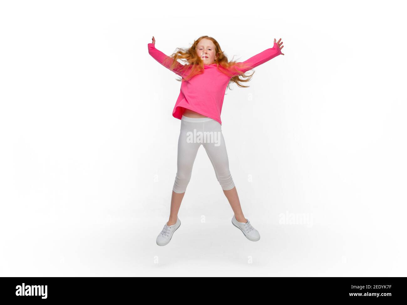 Smiling, jumping high. Happy, smiley redhair girl isolated on white ...