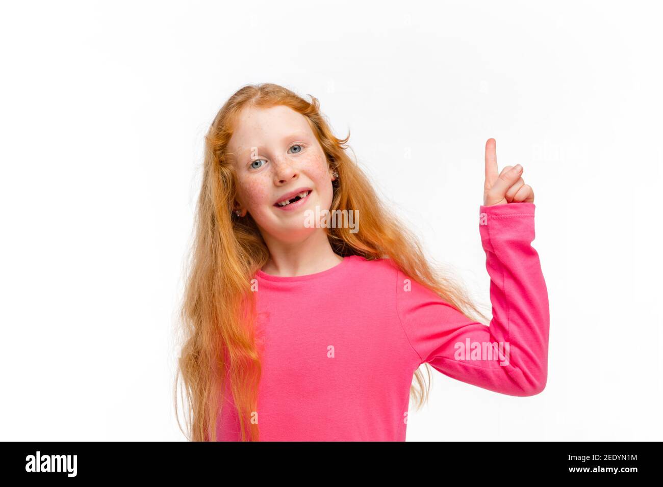 Cheerful Pointing Up Happy Smiley Redhair Girl Isolated On White