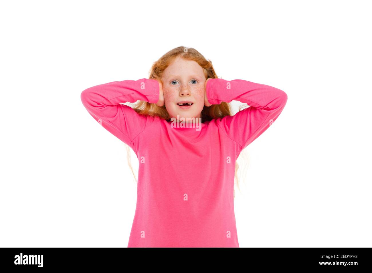Closing ears, shocked. Happy, smiley redhair girl isolated on white ...