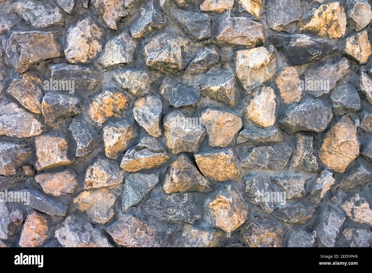 Fragment of the wall. Texture of concrete wall with granite rubble ...