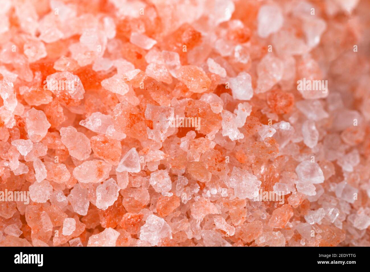 Pink coarse salt crystals on a blue table. Himalaya salt. Background ...