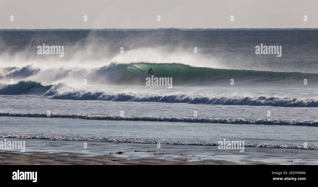Surfer getting barrelled in clean offshore surf winter 2021 Stock Photo ...