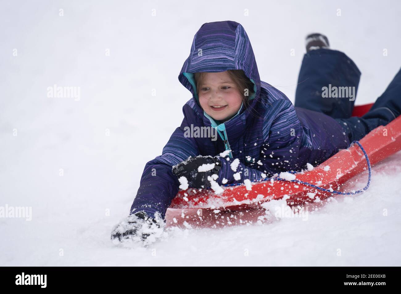 Female children sledding hi-res stock photography and images - Alamy