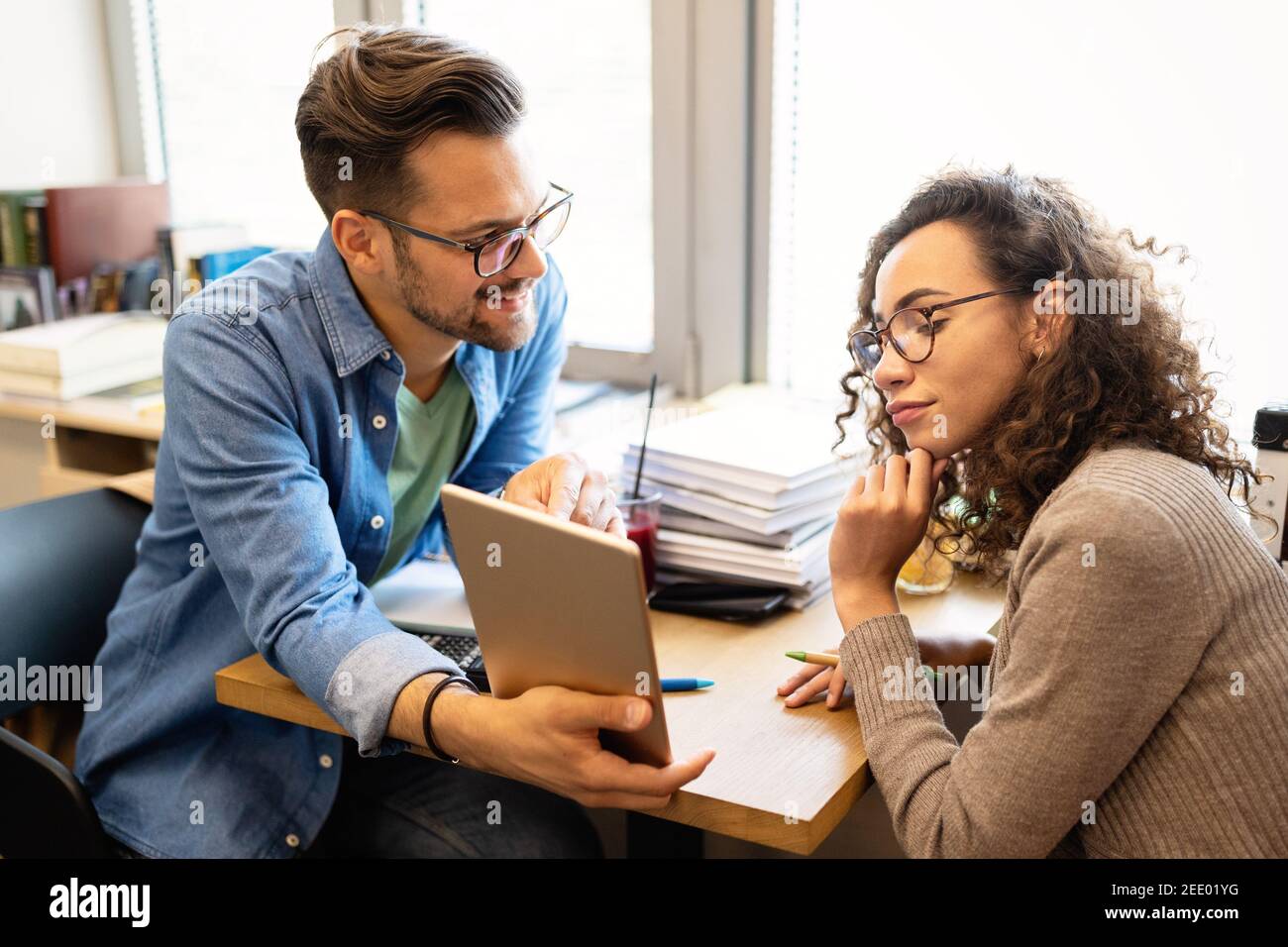 Students are studying together in library. Couple, study, technology ...