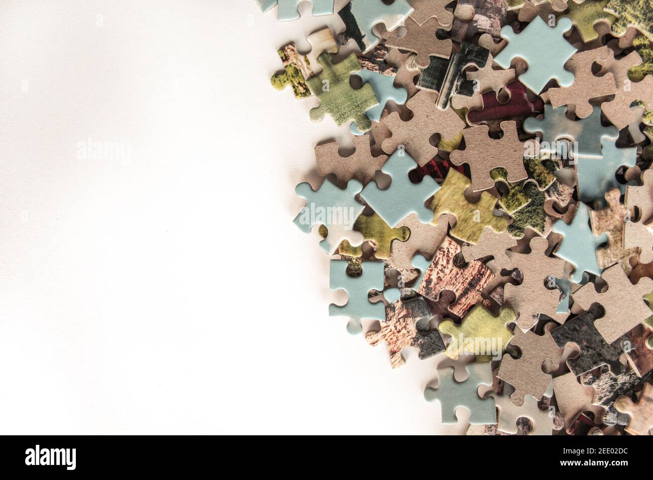 Puzzle. Background with half jigsaw puzzle and half white copy space ...