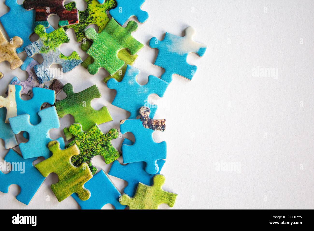 Puzzle. Background with half jigsaw puzzle and half white copy space ...