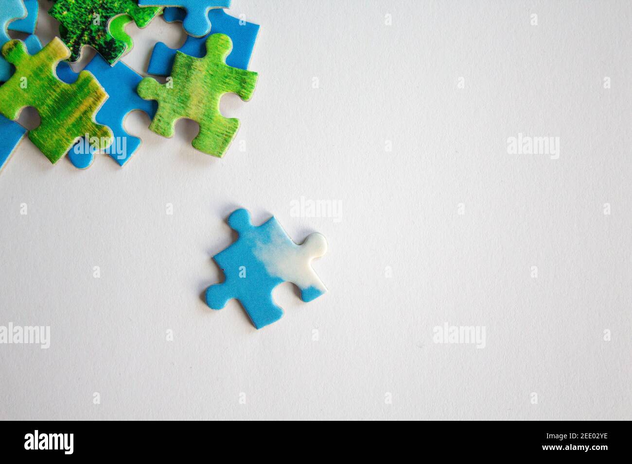 Puzzle. Background with half jigsaw puzzle and half white copy space ...