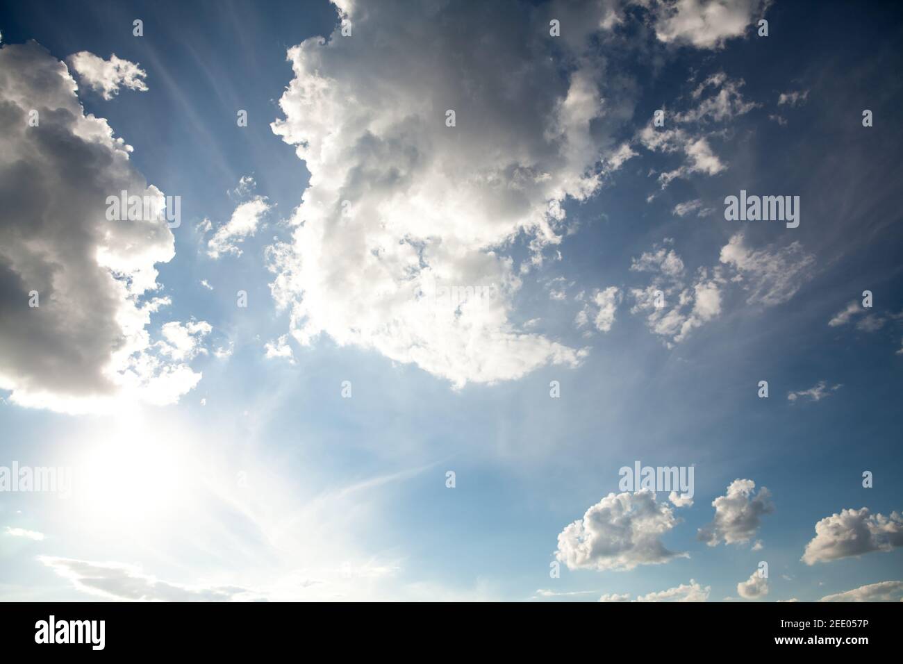 Surreal sun rays are striking through the clouds like an explosion ...