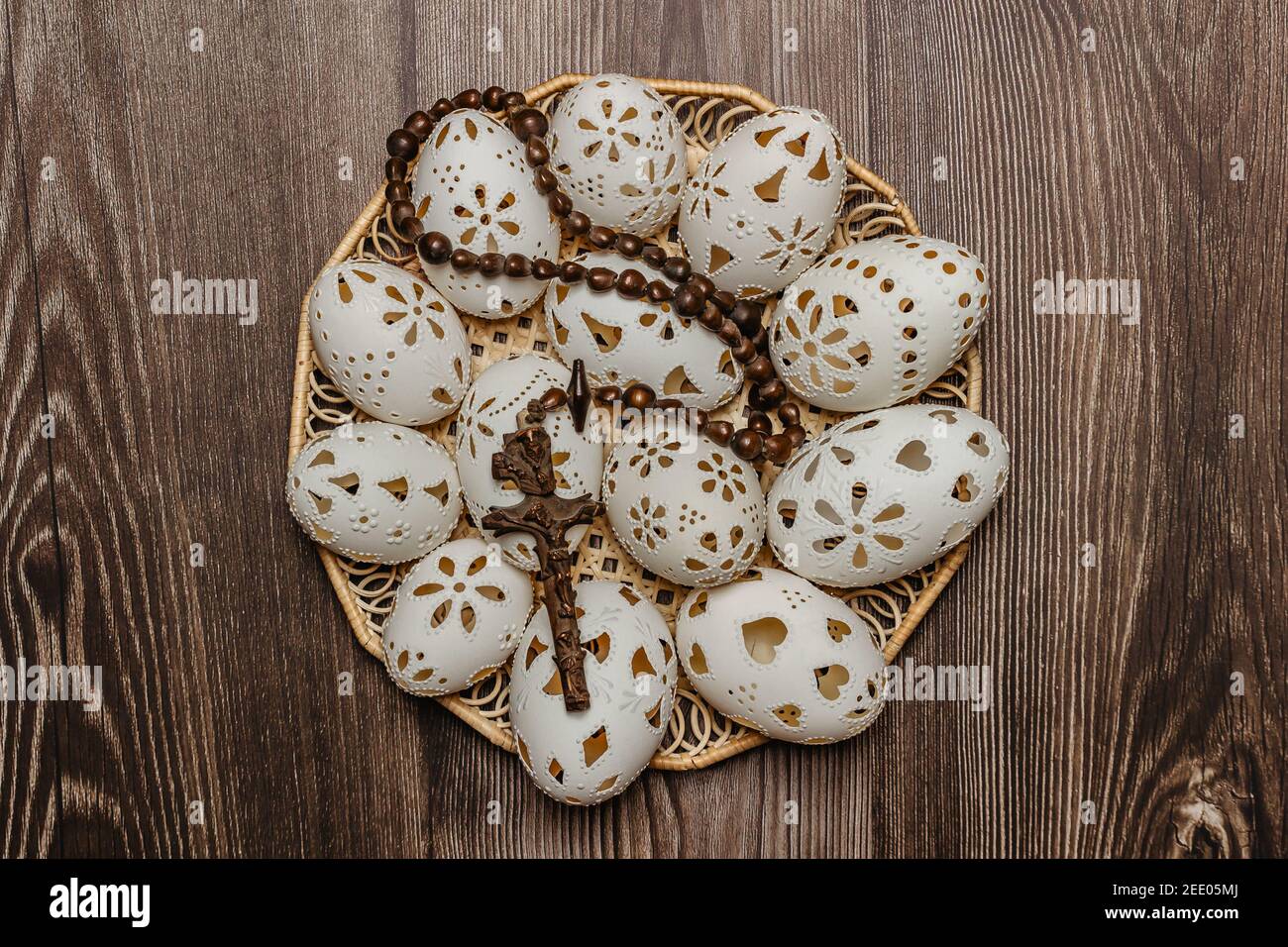 Happy Easter.White hand made Easter eggs with crucifix in wooden basket ...