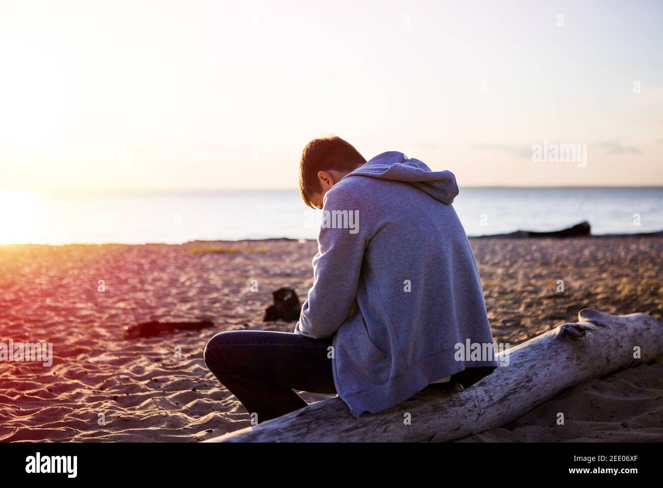 Sad and Lonely Young Man sit at Seaside Stock Photo - Alamy