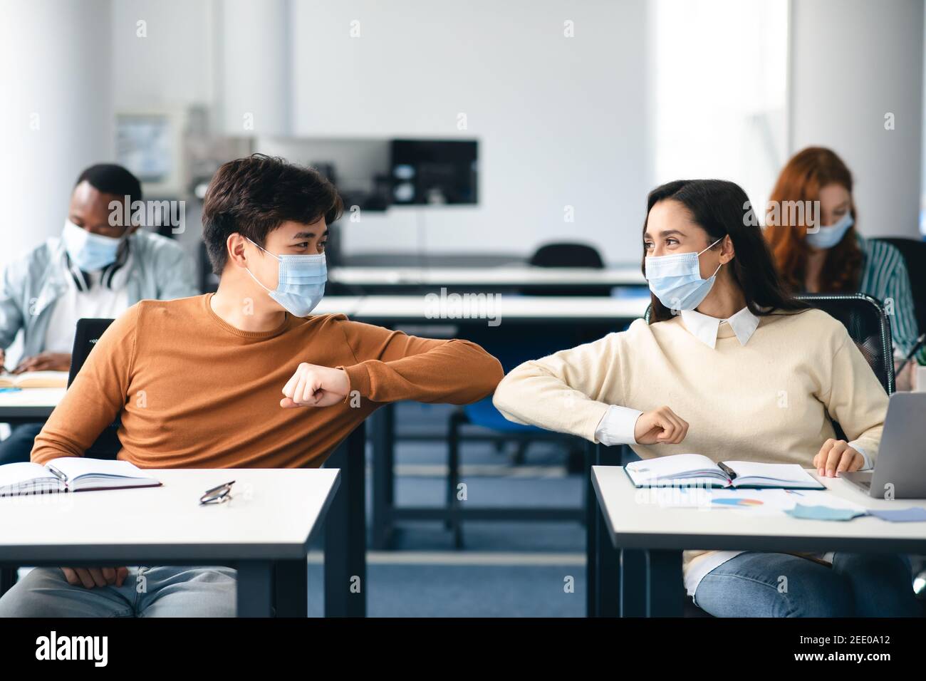 Student bumping elbows hi-res stock photography and images - Alamy