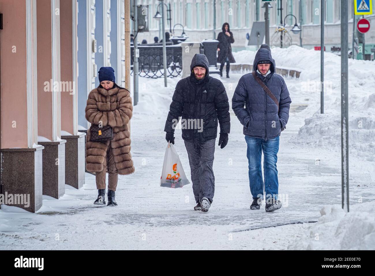 Russia, Moscow. People walk in a street. Moscow hit by snowfall. The ...