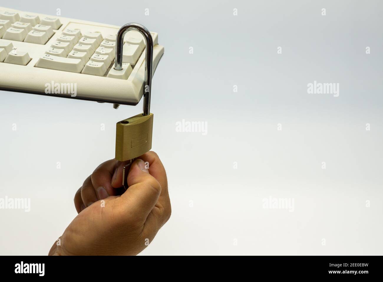 Computer keyboard unsecured with an open padlock. White text free space ...