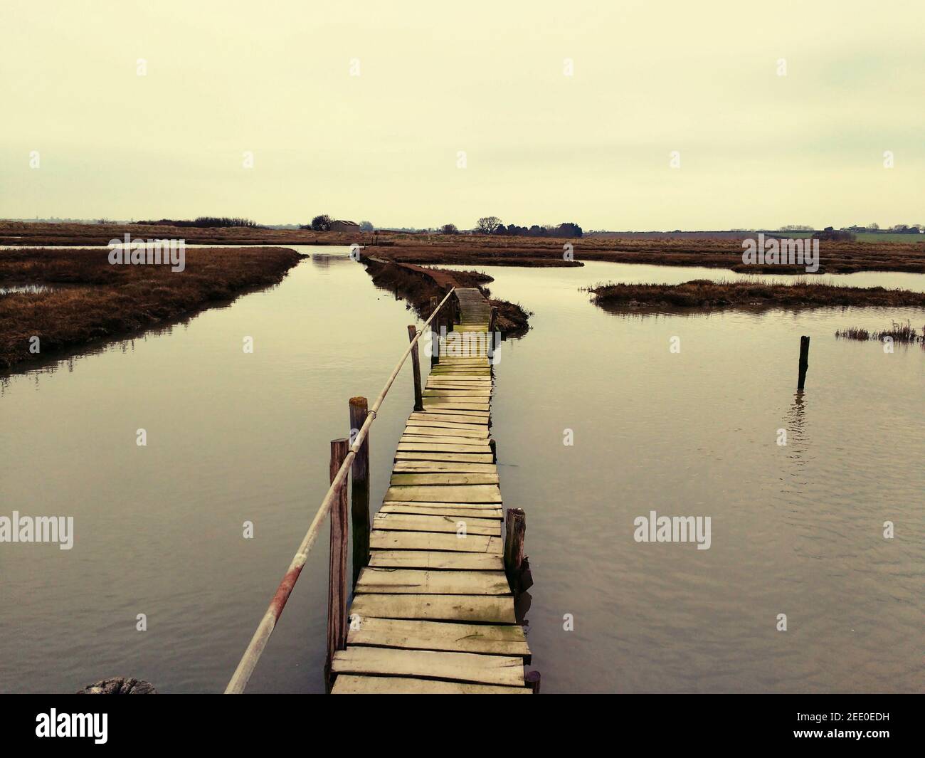 A wooden path across the surface of tranquil water Stock Photo - Alamy