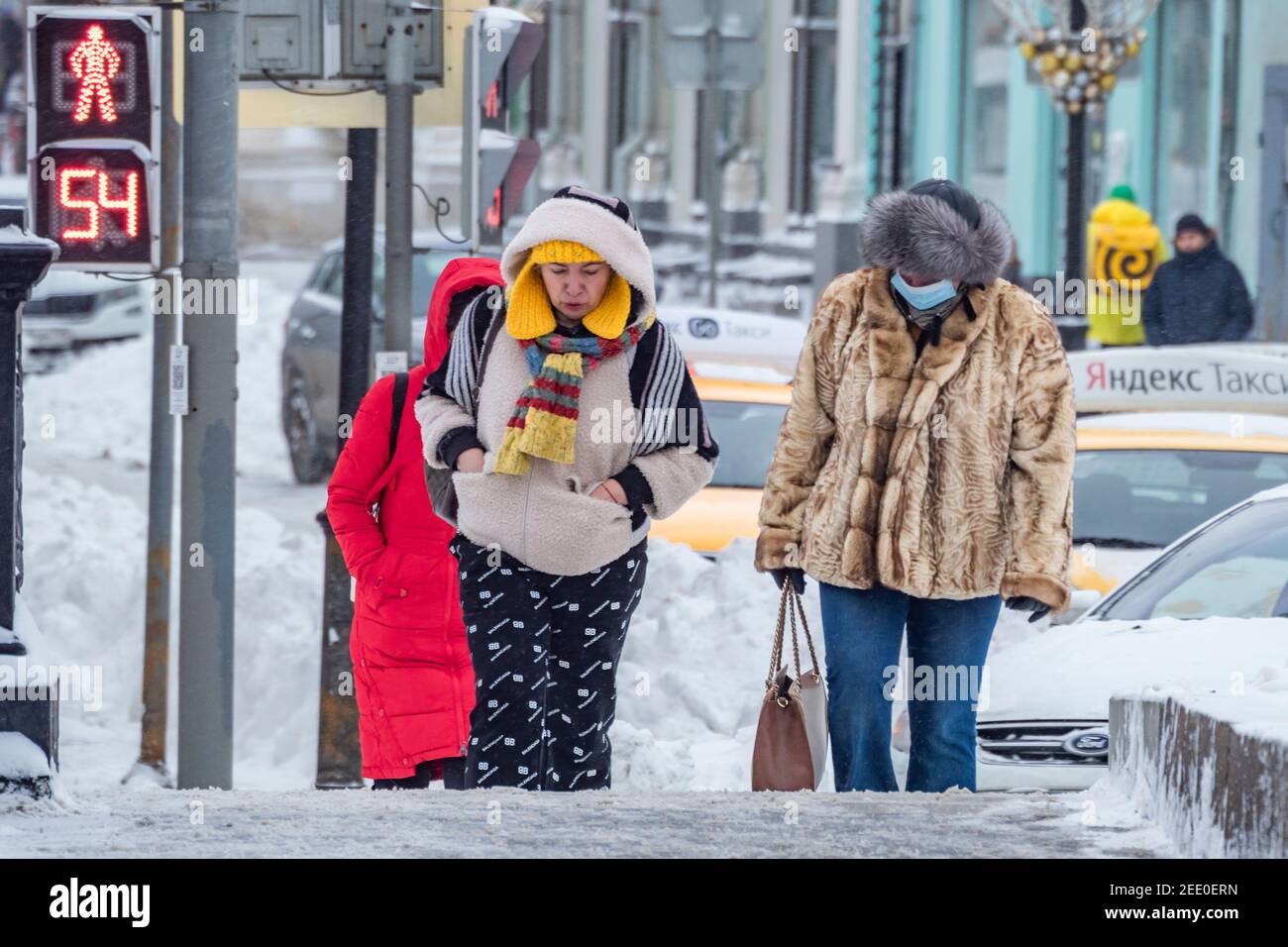 Russia, Moscow. People walk in a street. Moscow hit by snowfall. The ...