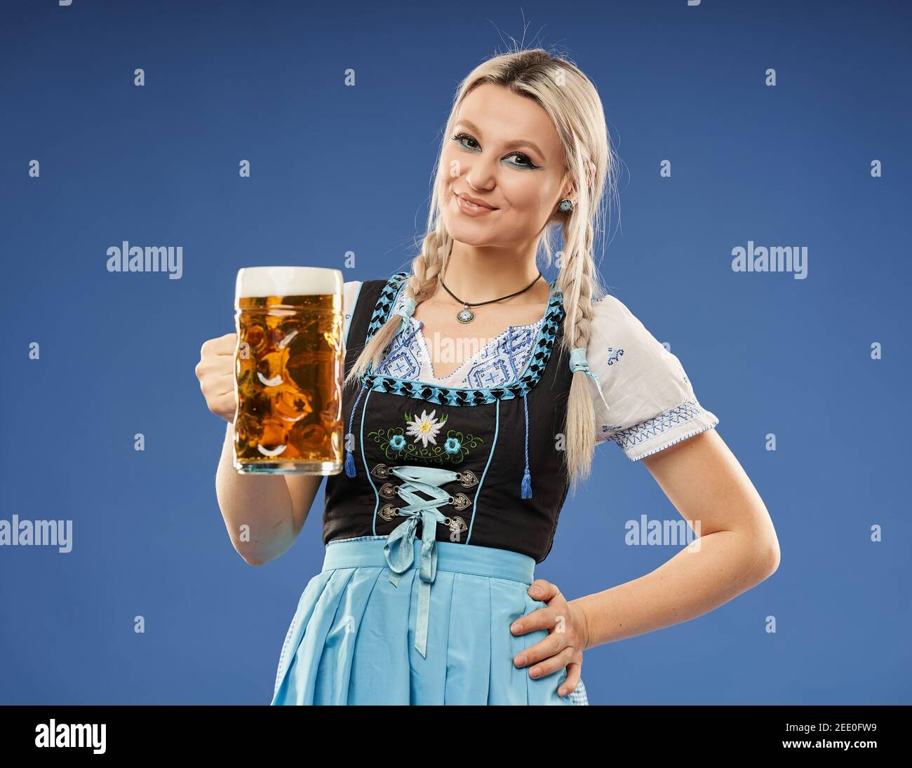 Blonde German Young Woman In Traditional Costume With A Pint Of Beer