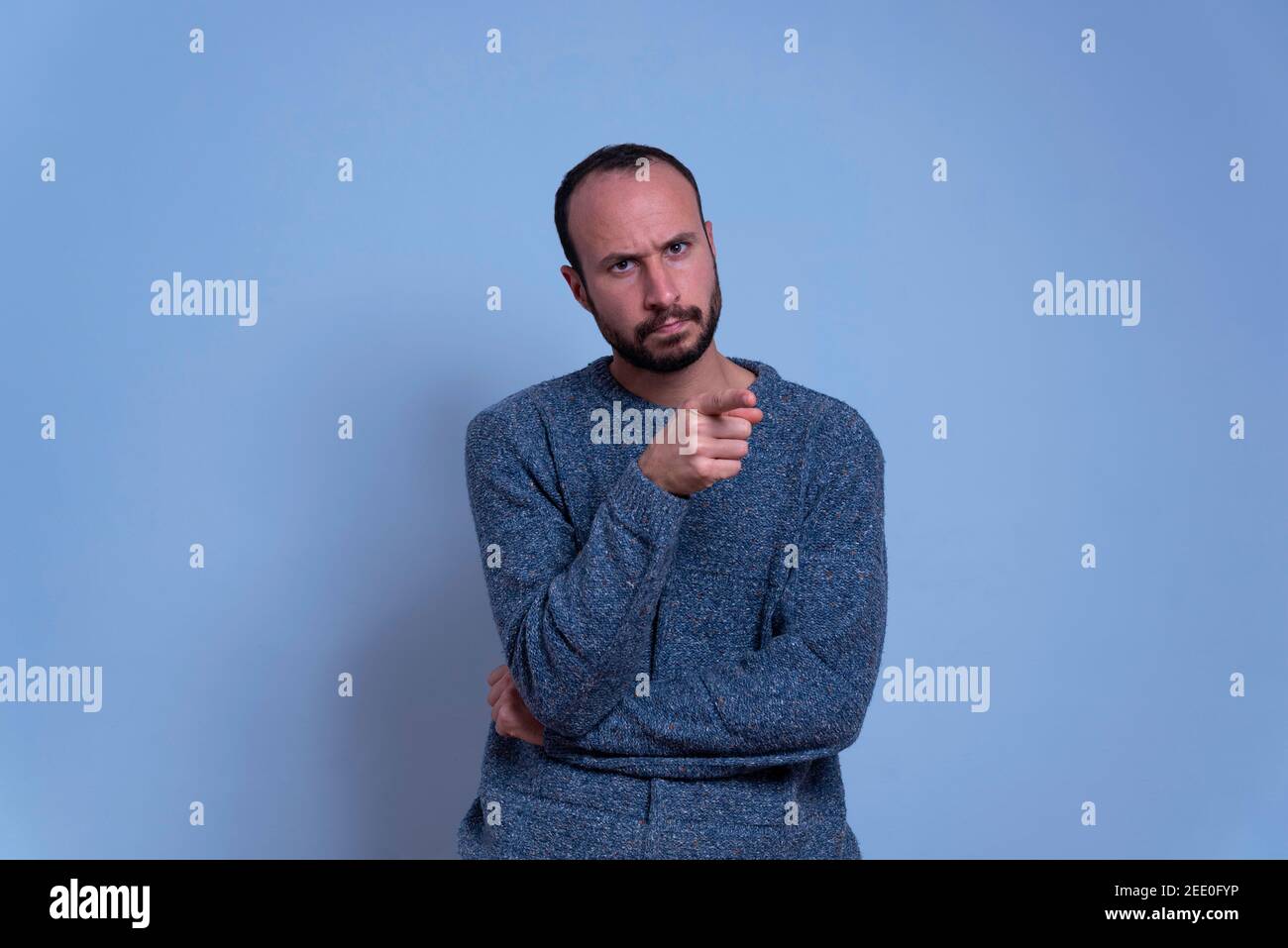 man with severe and angry expression pointing finger in sign of accuse ...