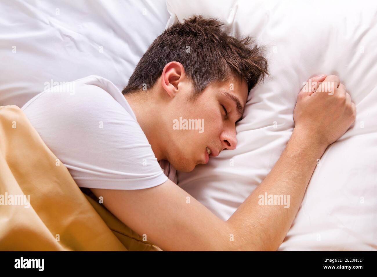 Tired Young Man sleep in the Bed at the Home Stock Photo - Alamy