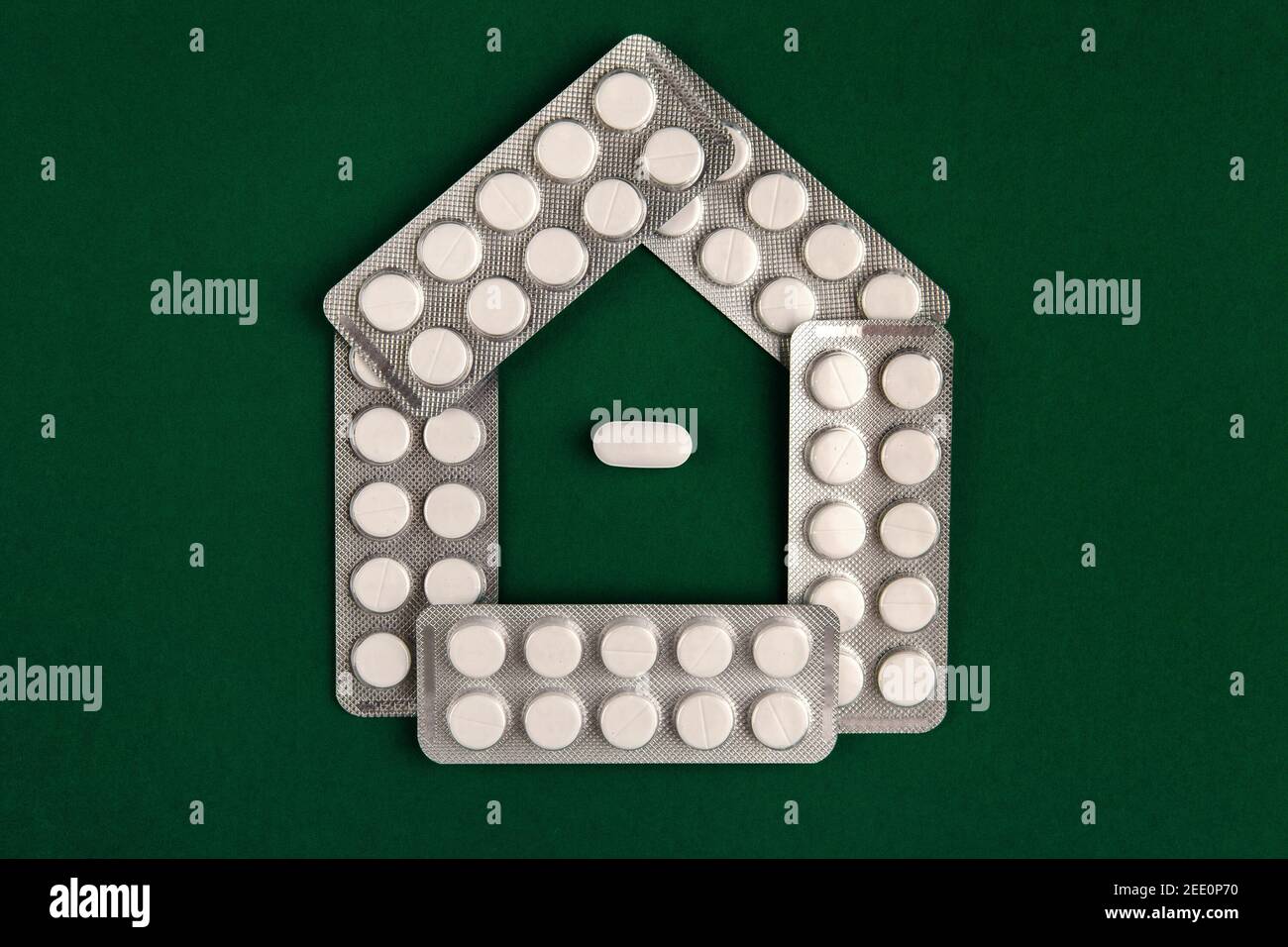 Pills Set in House Shape on the Green Paper Background closeup Stock ...