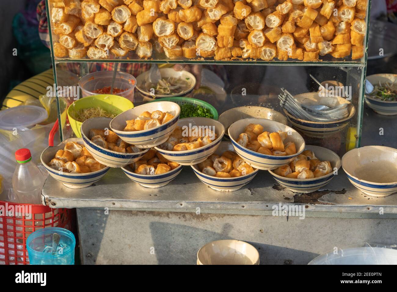 Cut deep-fried bread sticks - youtiao at breakfast vendor on the street ...